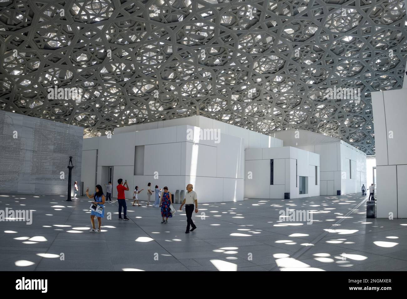 Visitors in the light rain of the Louvre Abu Dhabi, architect Jean ...
