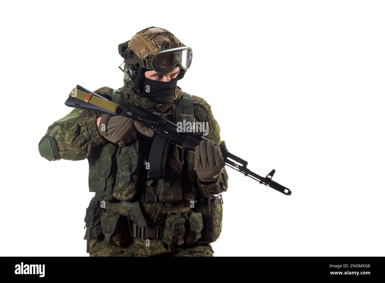 Russian soldier mercenary with a machine gun carefully looks to the ...