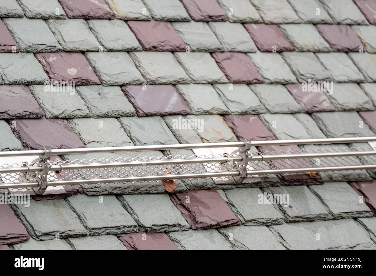 Slate roofing tiles with snow and ice guard on a historic building ...