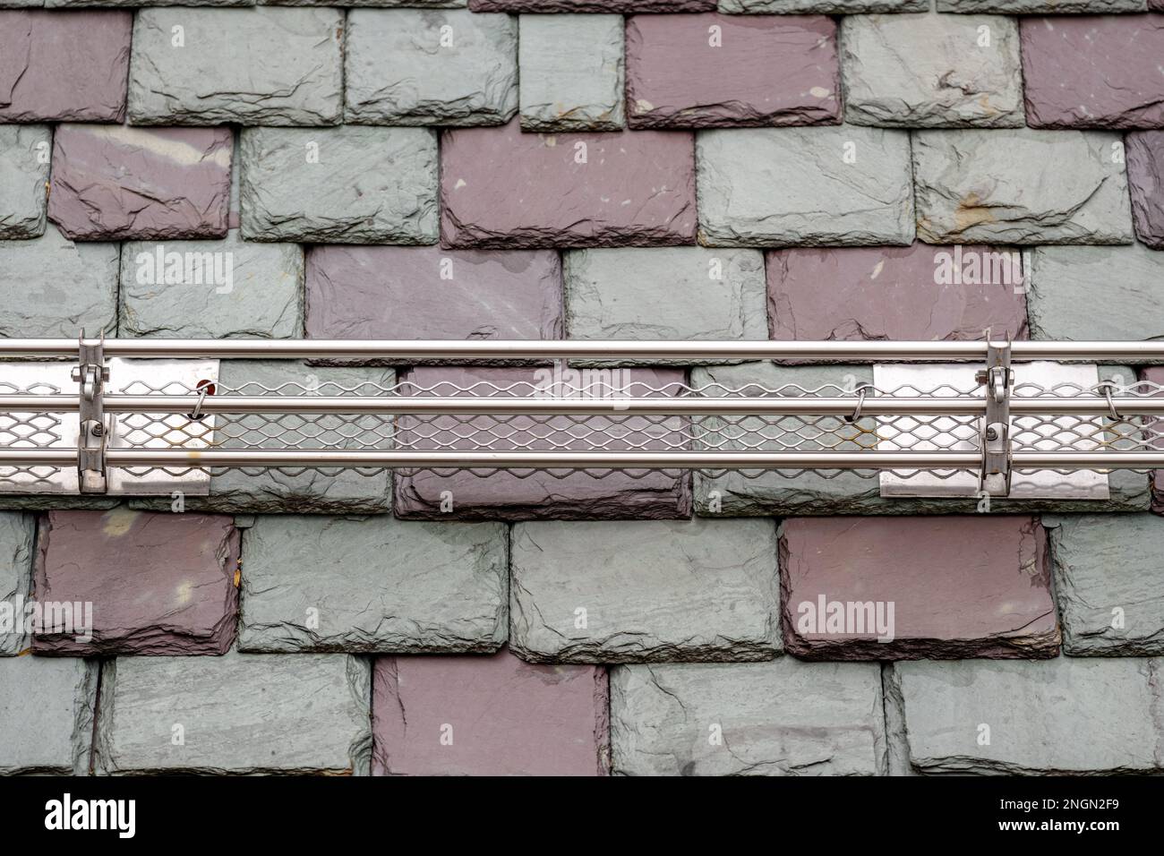 Slate roofing tiles with snow and ice guard on a historic building ...