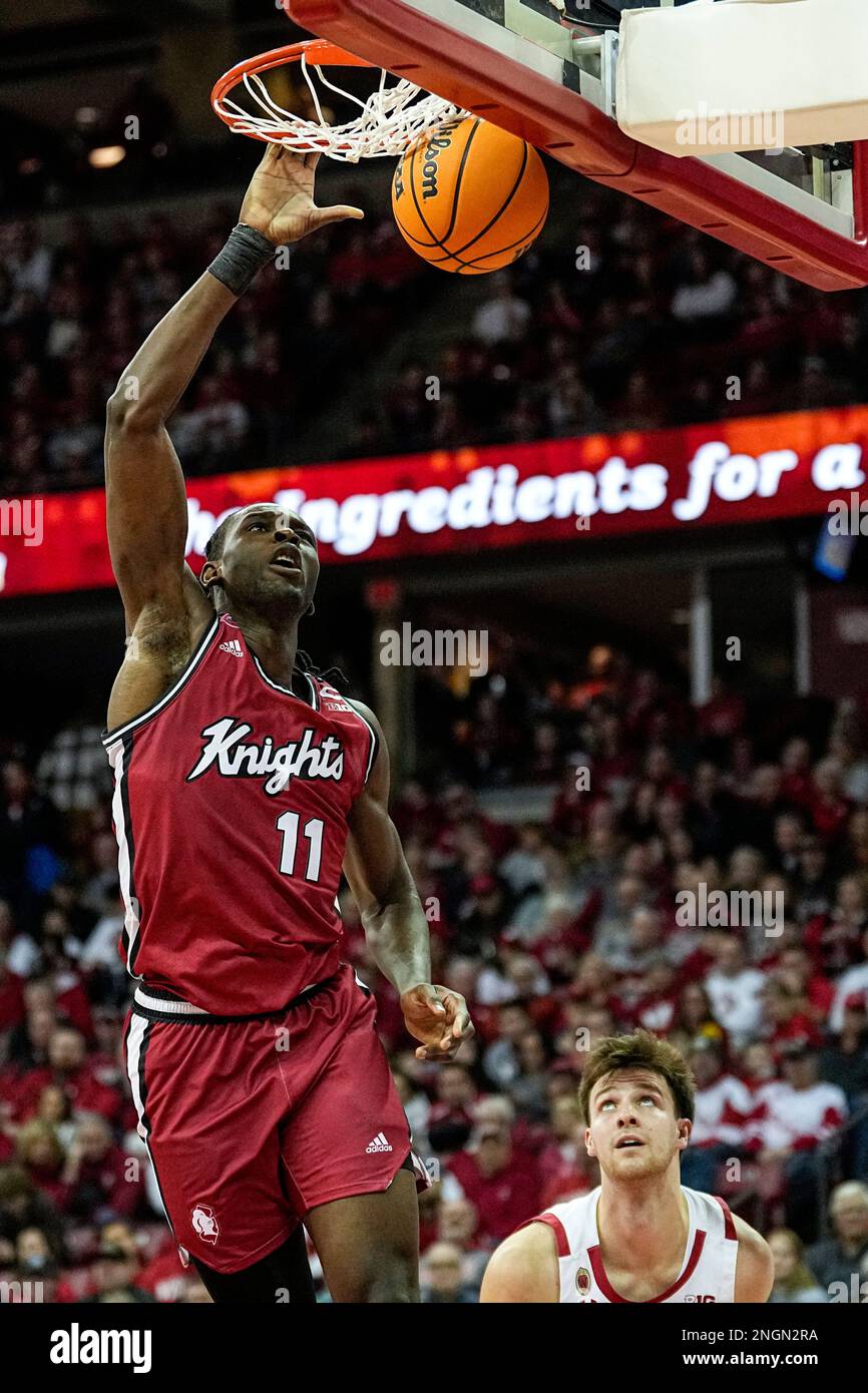 Rutgers' Clifford Omoruyi (11) dunks past Wisconsin's Carter Gilmore ...