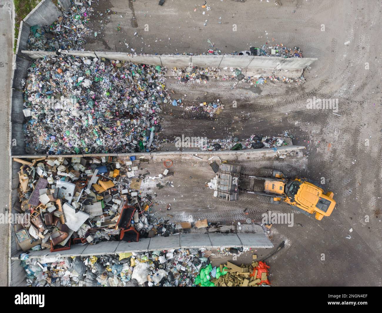 Wheel loader on the landfill site, pushing, scooping and carrying waste ...