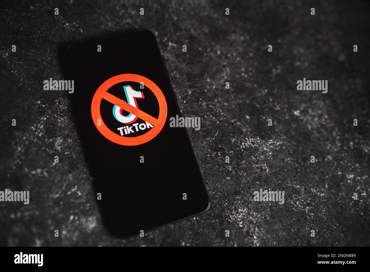 TikTok app logo crossed out with red Ban sign displayed on phone screen ...
