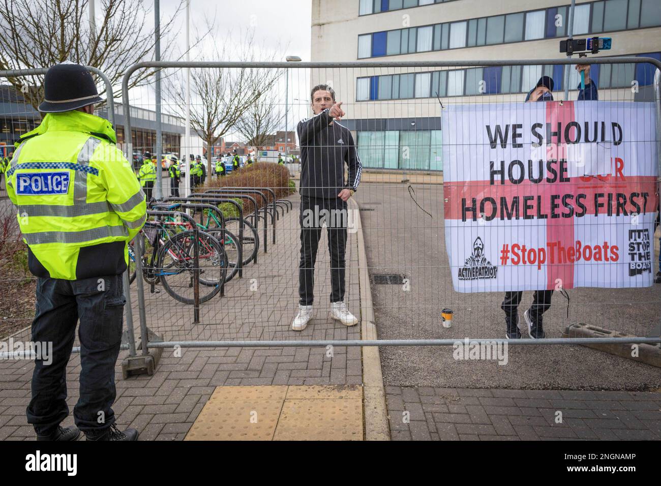 Rotherham, UK. 18th Feb, 2023. An anti-immigration demonstrator points ...