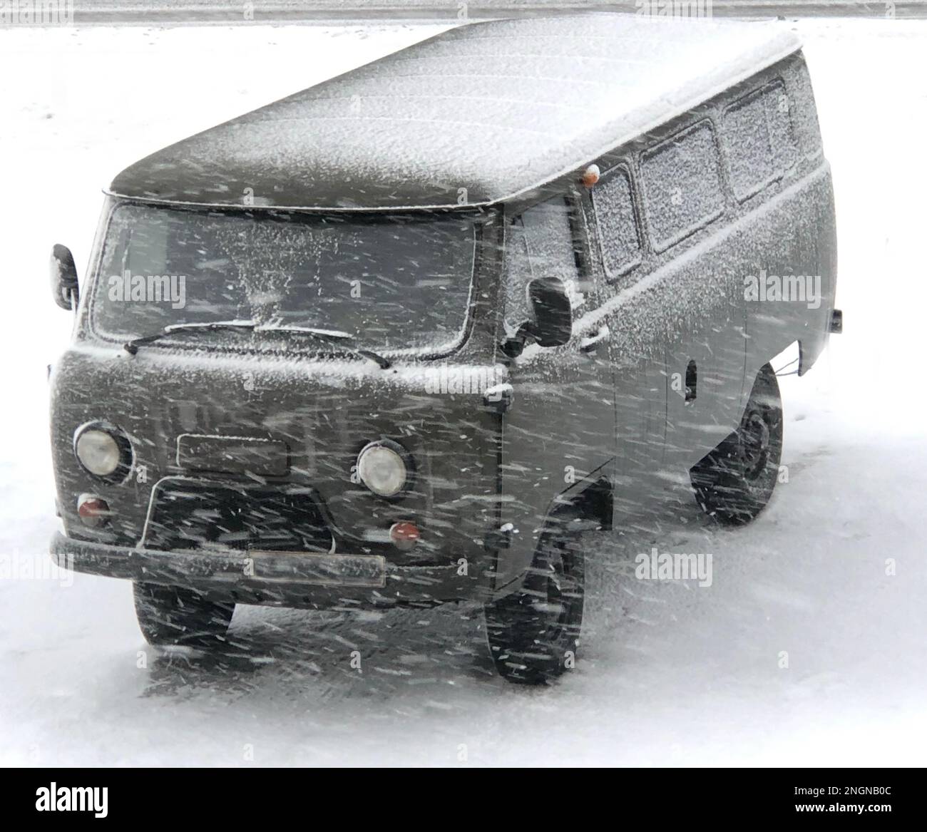 green military car in the snow in a blizzard Stock Photo - Alamy