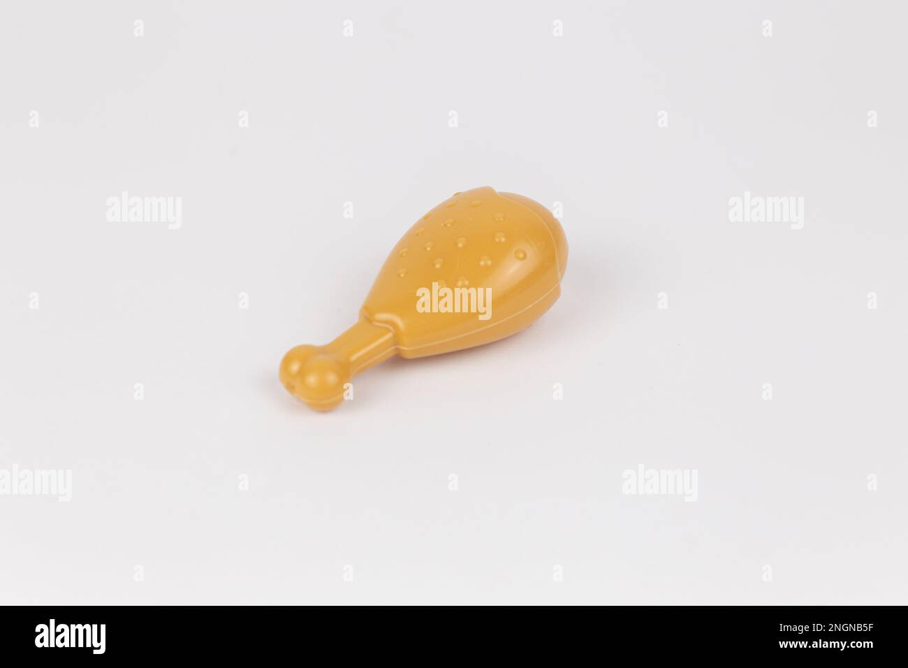 a chicken leg plastic toy child on a white background Stock Photo - Alamy