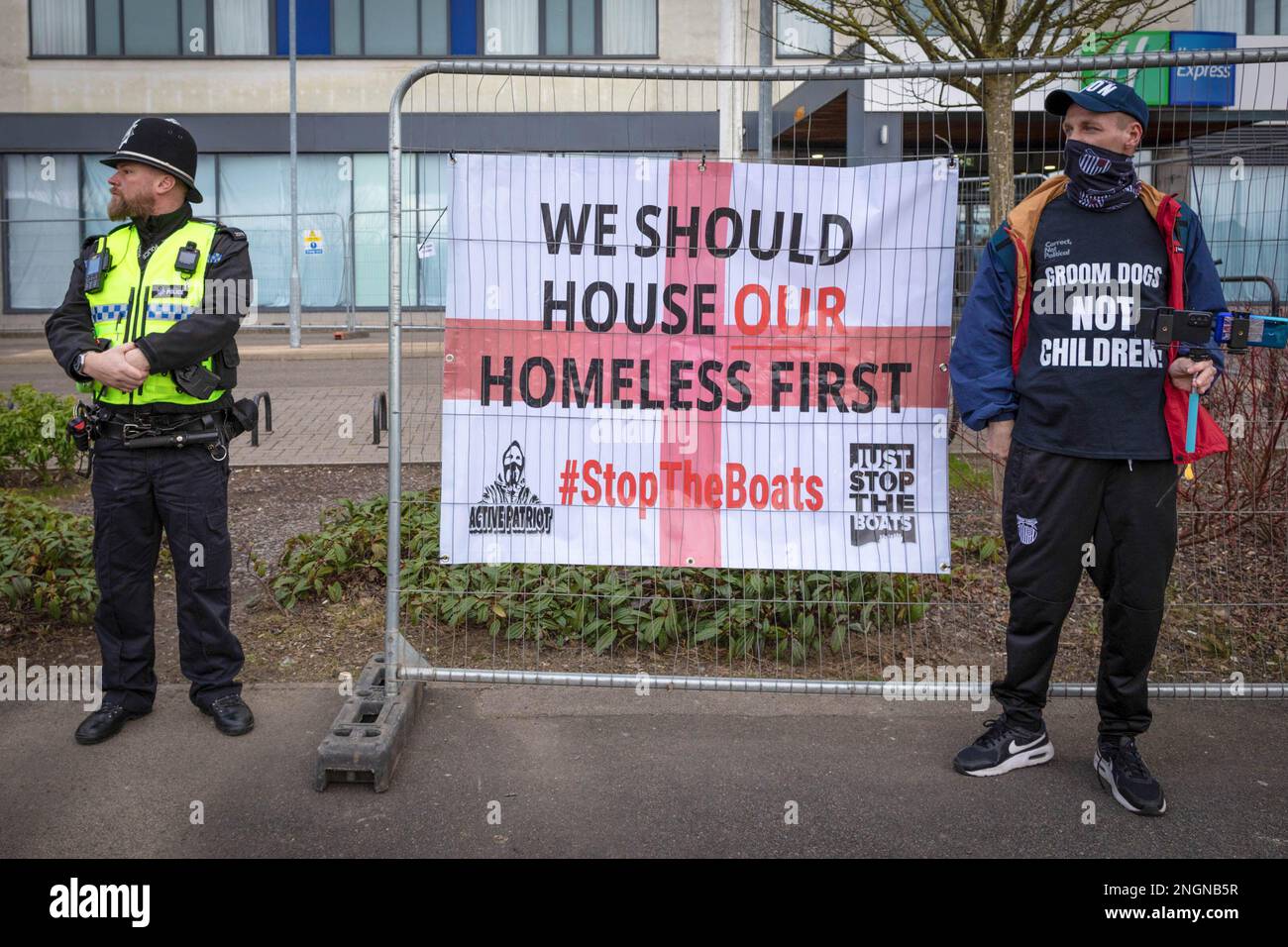 Rotherham, UK. 18th Feb, 2023. An anti-immigration demonstrator stands ...