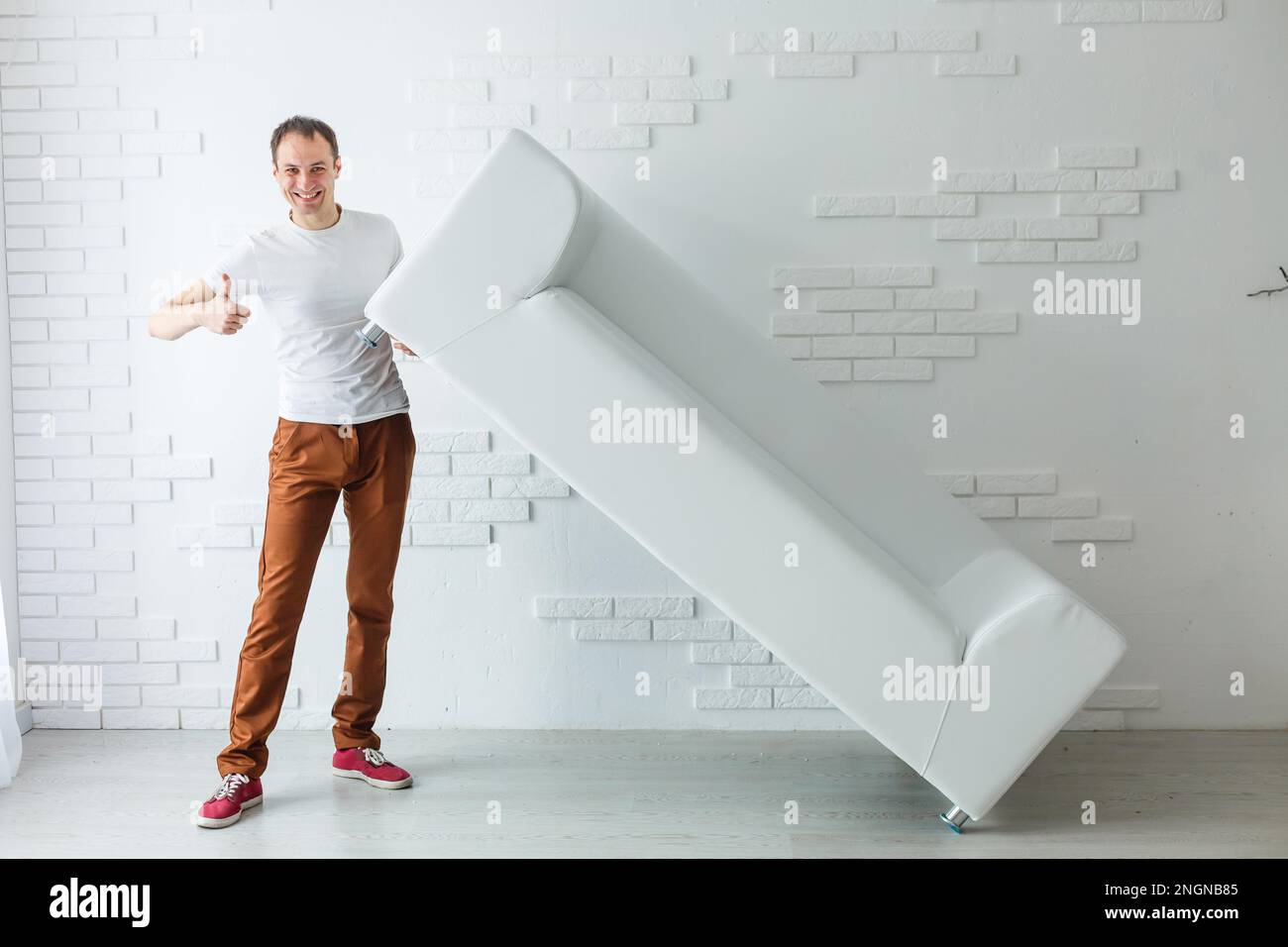 Mover guy lifting up couch hi-res stock photography and images - Alamy