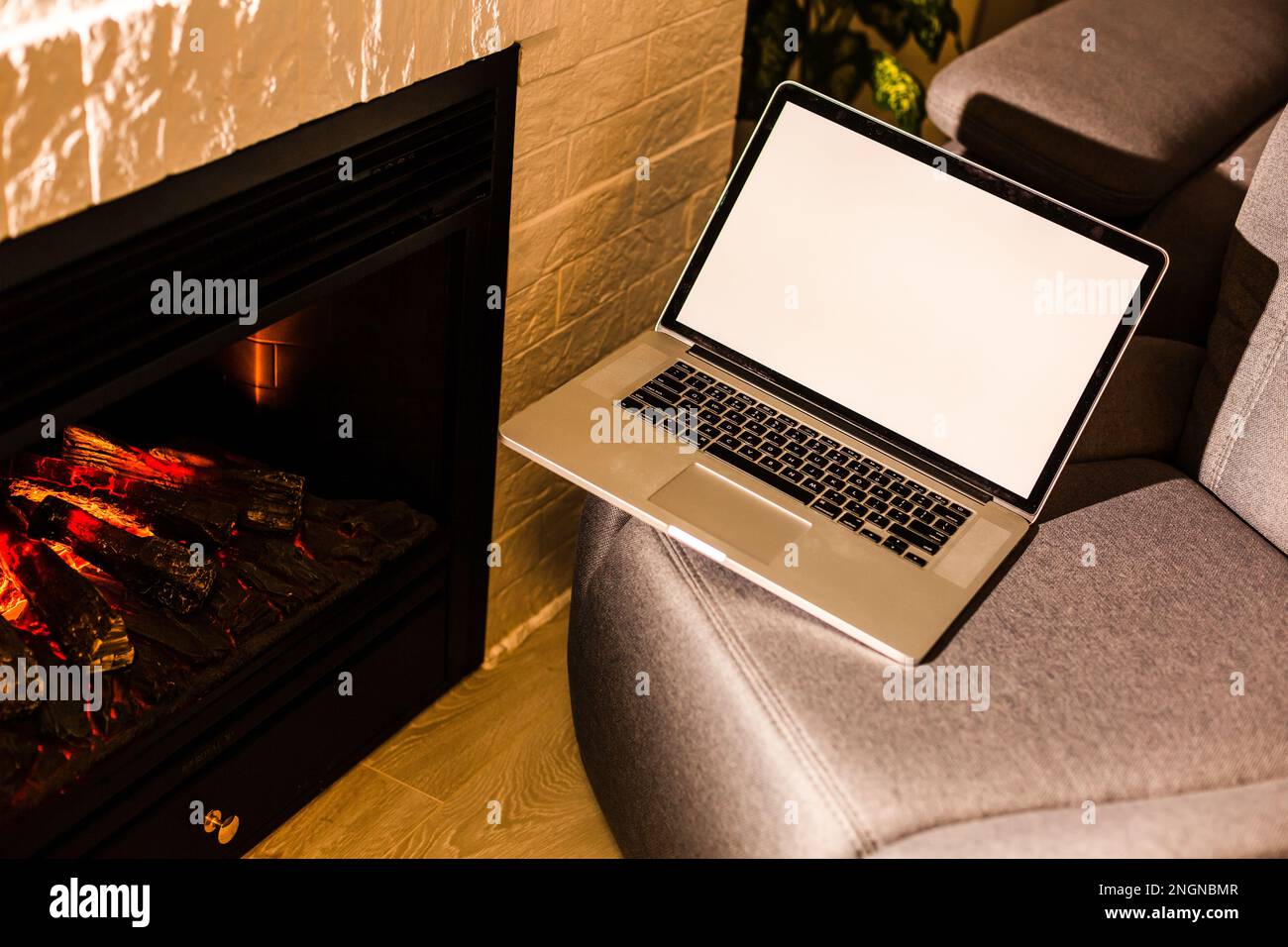laptop and pile of books against the background of the fireplace Stock ...