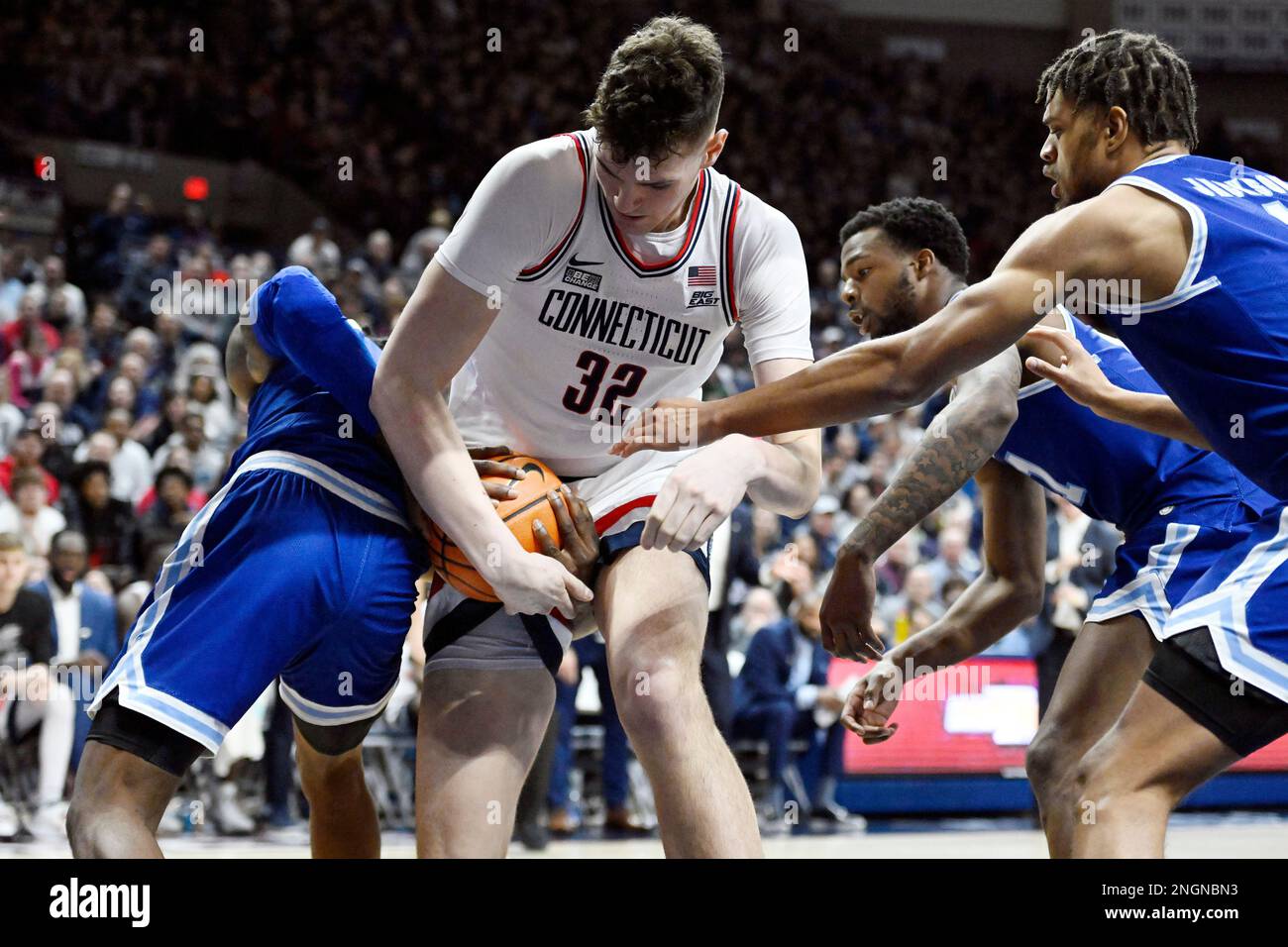 Seton Hall's KC Ndefo, right, reaches between the legs of UConn's ...