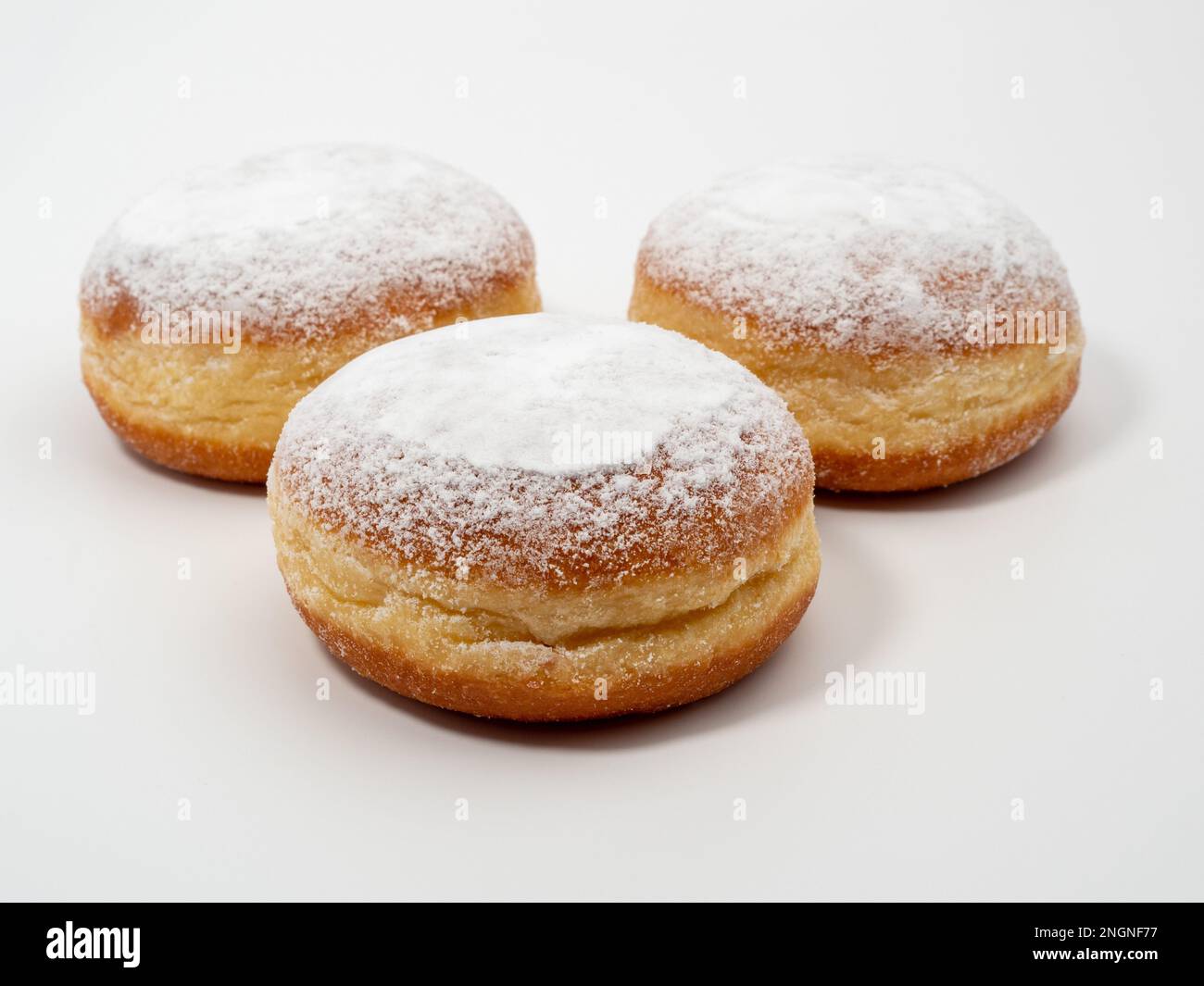 Freshly baked and dusted with powdered sugar German donuts. Donut ...