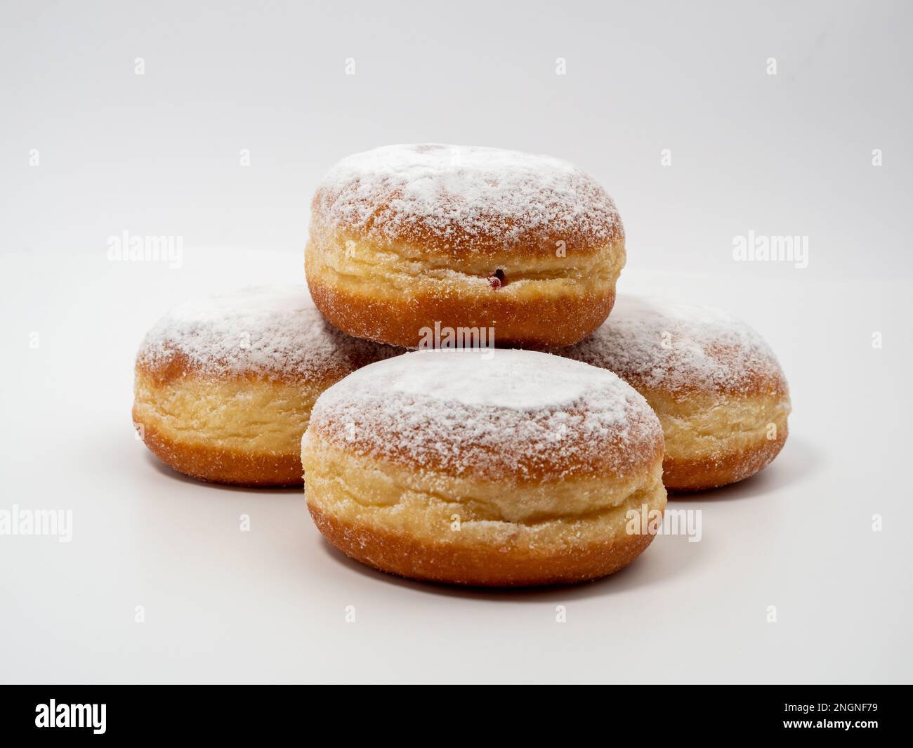 Freshly baked and dusted with powdered sugar German donuts. Donut ...