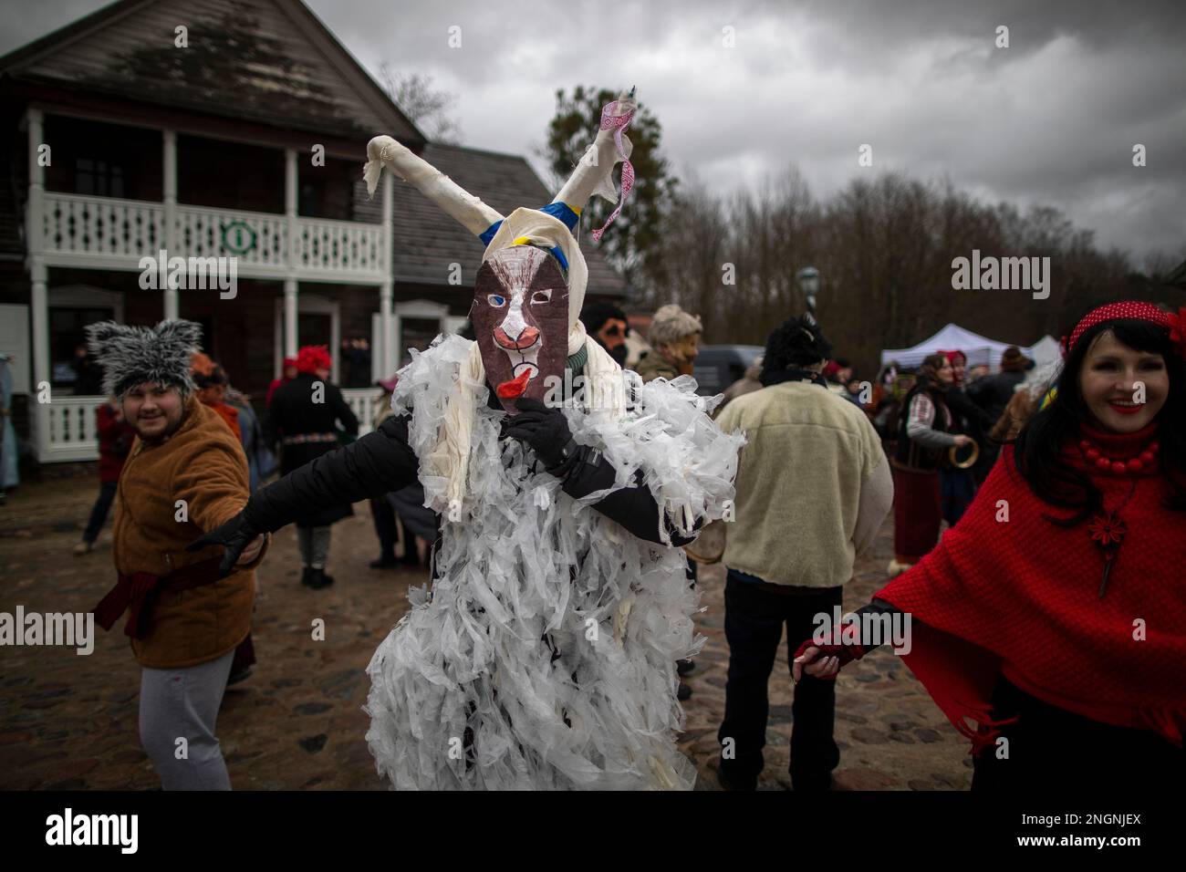 Revelers wearing traditional carnival masks dance during Shrovetide ...