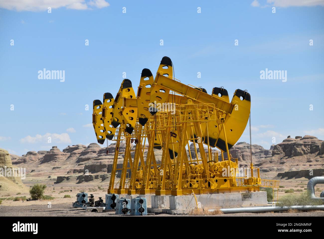 The large yellow oil rigs industrial setting, sky in the background ...
