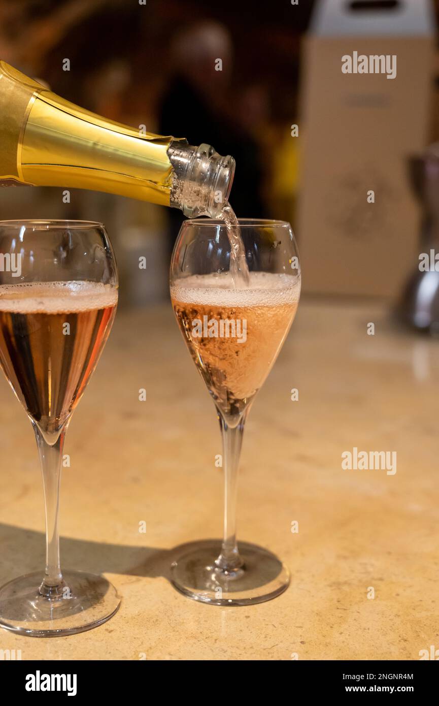 Tasting of rose champagne sparkling wine produced by traditional method in dark underground ...