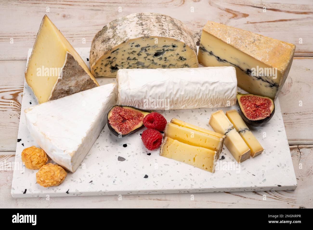 Cheese collection, marble board with French cheeses brie, tomme ...