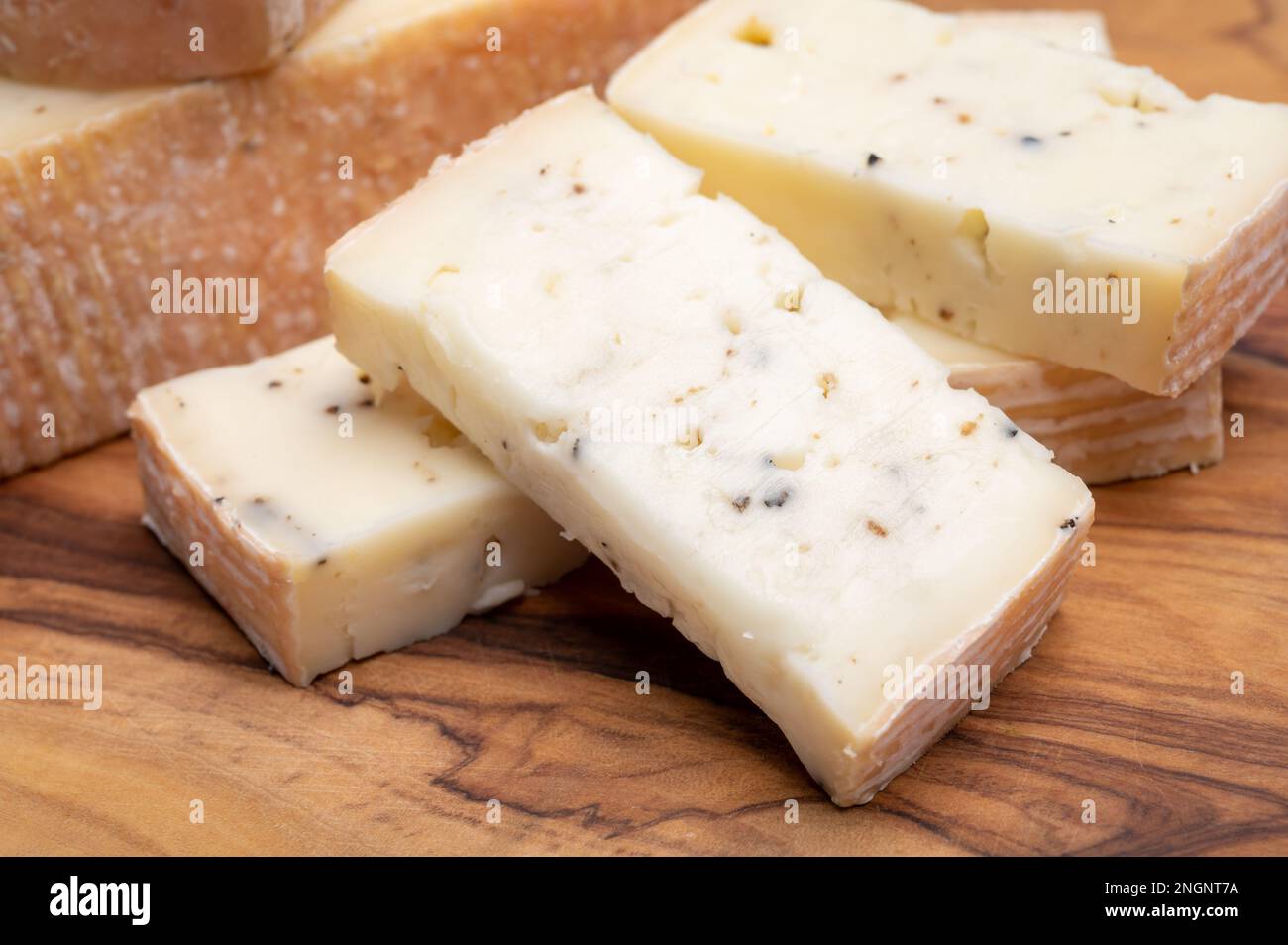 Italian cheese collection, yellow taleggio cheese with black truffles ...