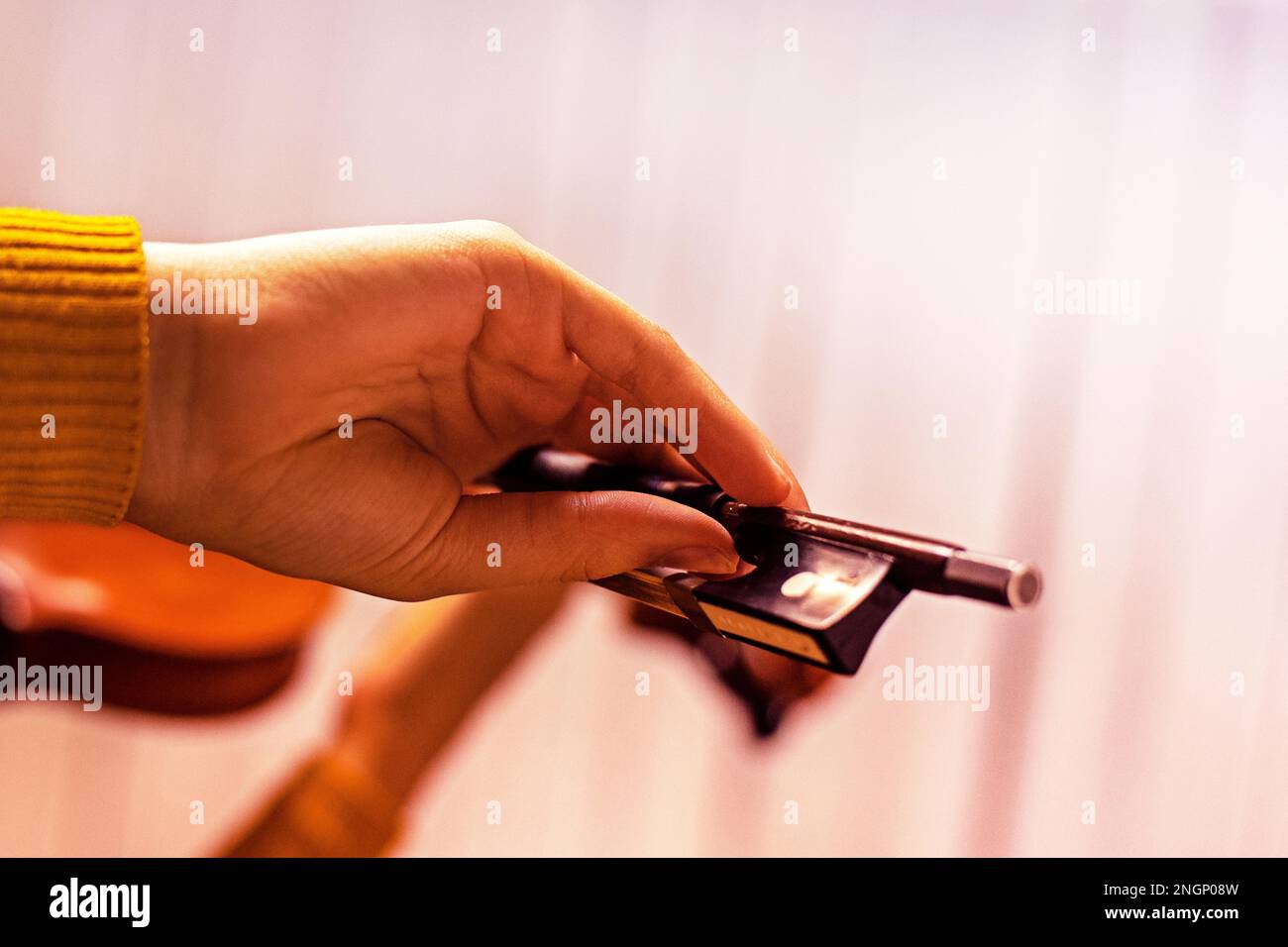 right hand of a young violinist plays a student's violin with a bow on ...