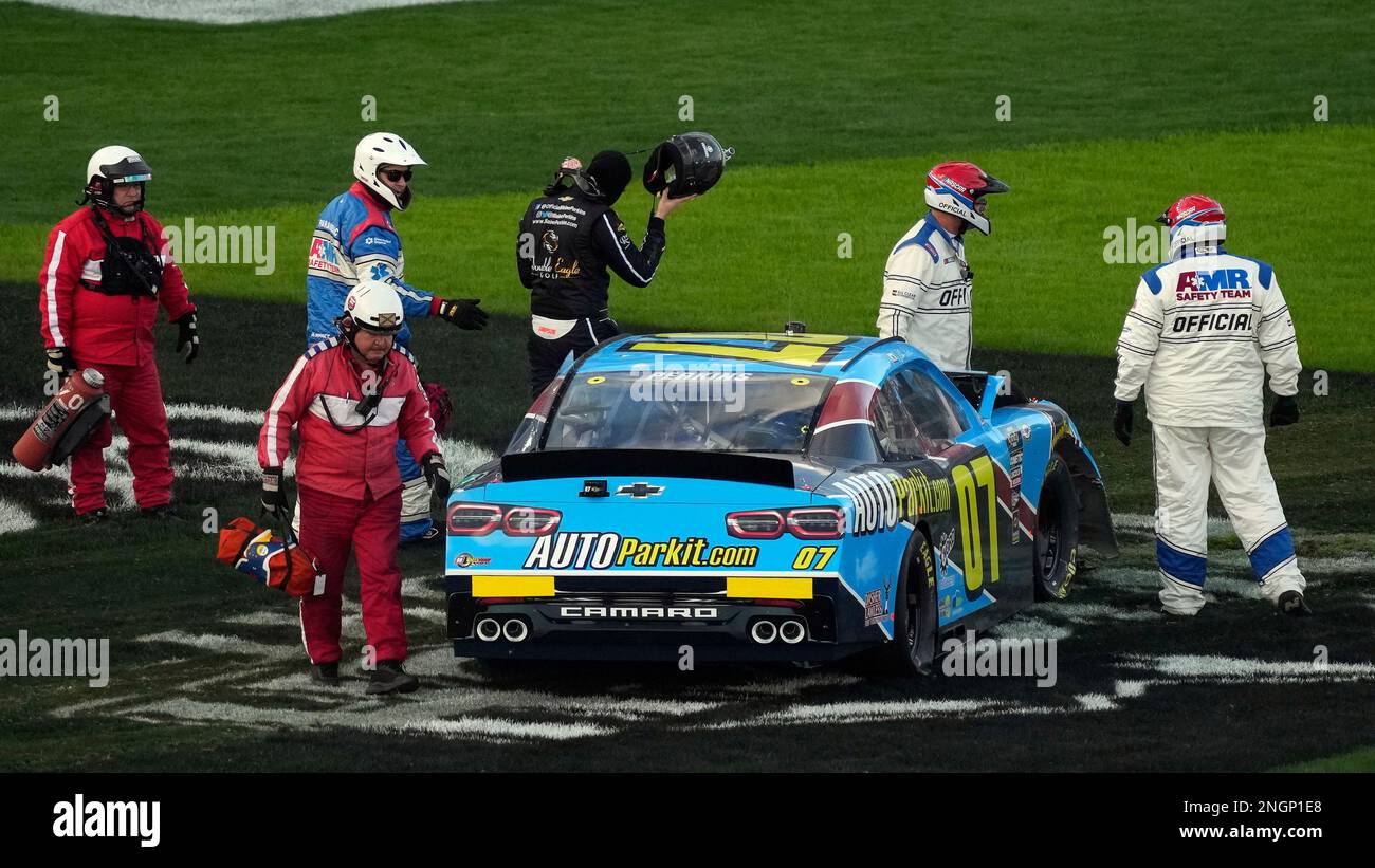Blaine Perkins, center, is helped from his car after crashing during ...
