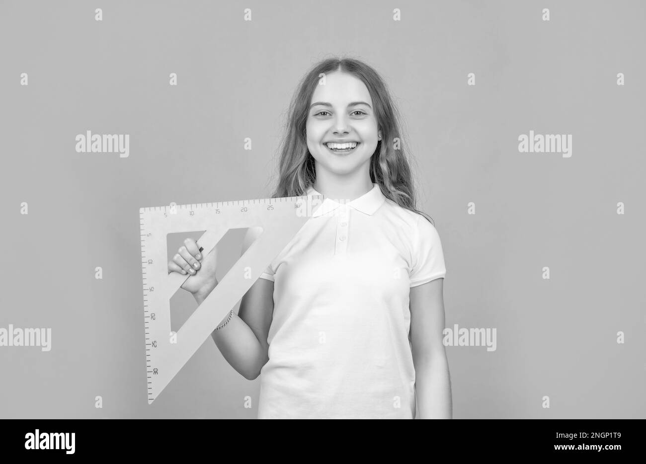 positive child with math triangle measuring tool Stock Photo - Alamy