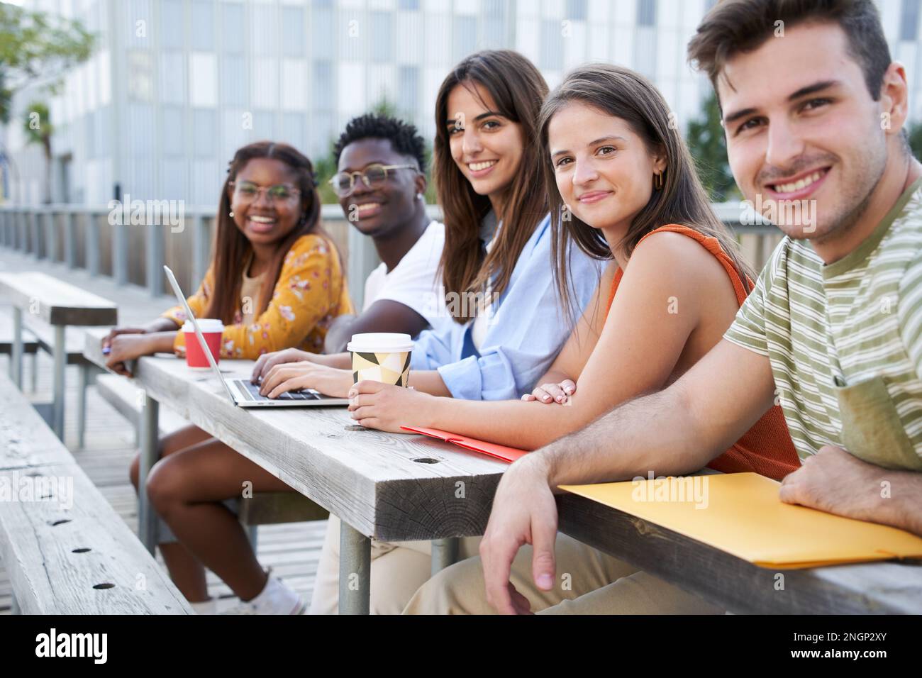 Group of cheerful students together posing happily looking at camera ...