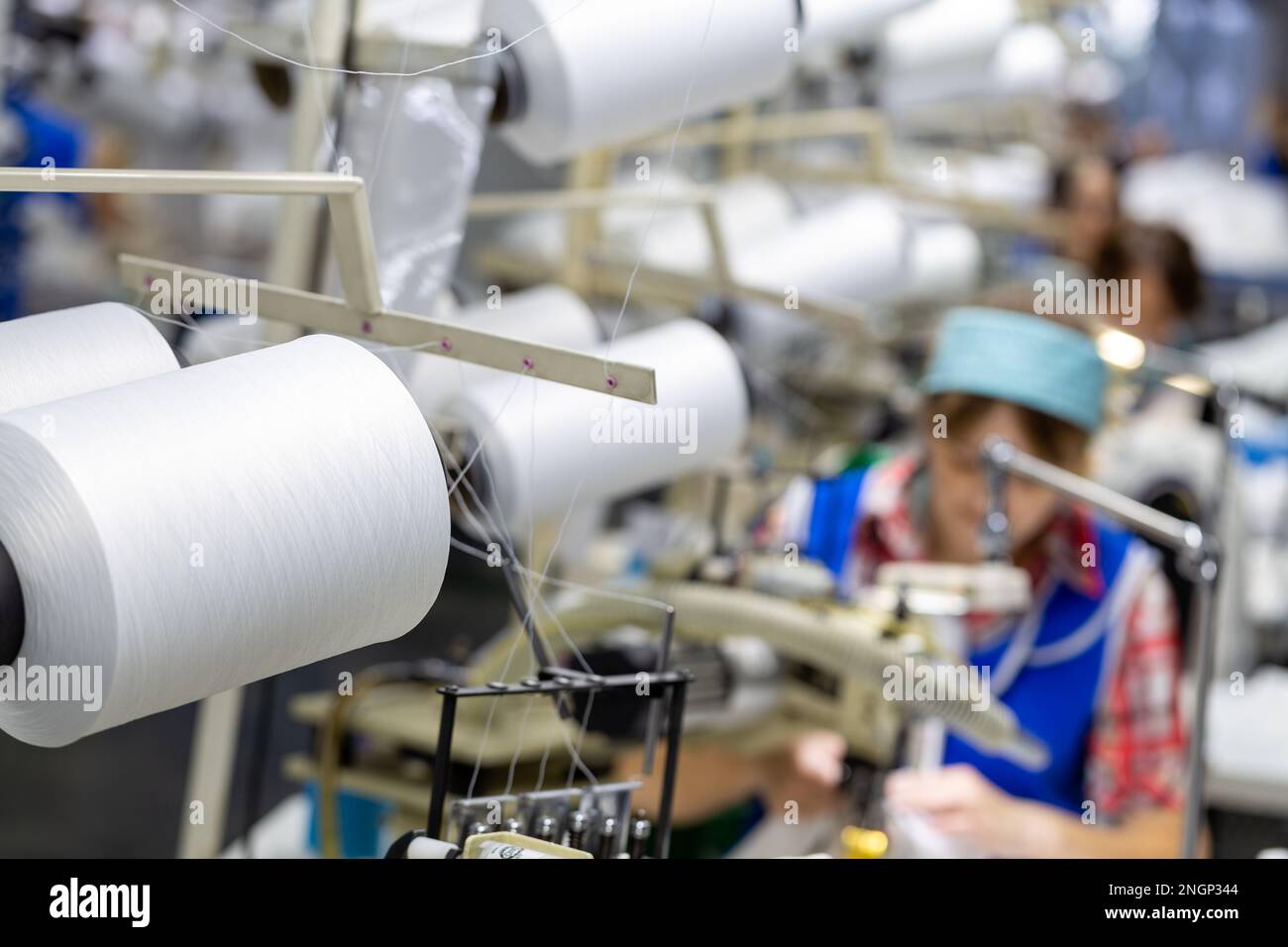 Blurred background with women are engaged in tailoring of tights in a ...