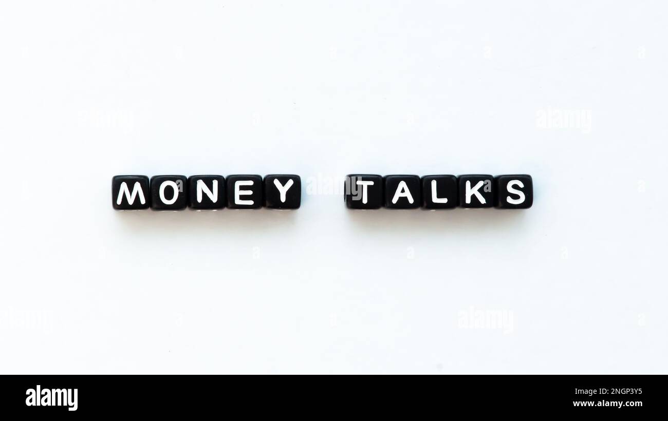 Money talks quote in black letter beads on white background. Wealth and ...