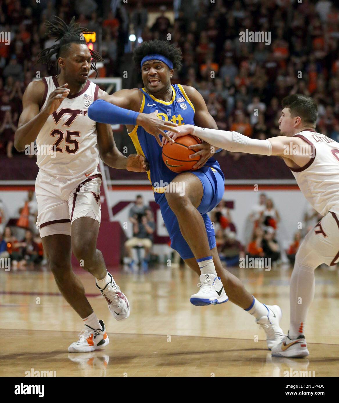 Pittsburgh's Blake Hinson, center, drive through defender Virginia Tech ...