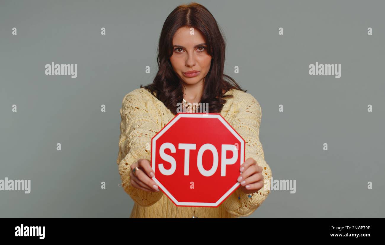 Serious pretty woman say No, hold inscription text red No stop danger ...