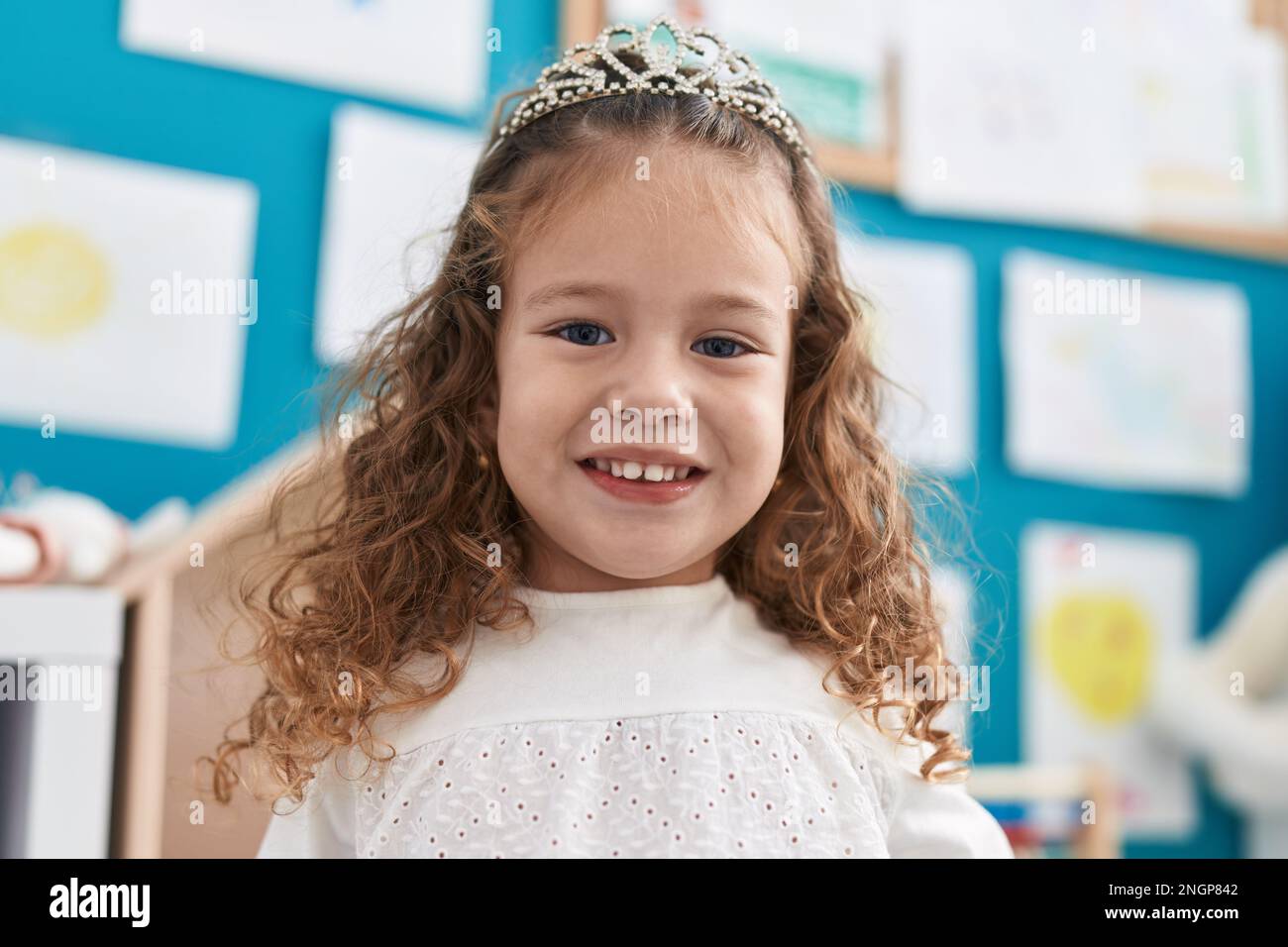 Adorable blonde toddler smiling confident wearing princess crown at kindergarten Stock Photo - Alamy