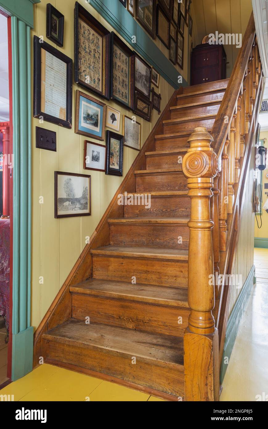 Maple wood staircase and wall decorated with vintage photographs and ...