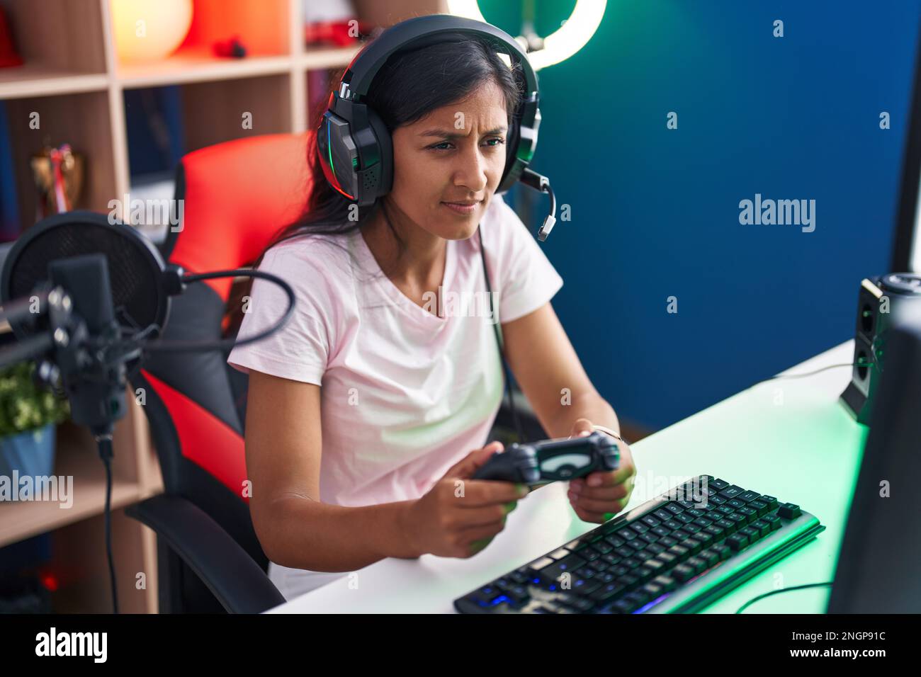 Young beautiful hispanic woman streamer playing video game using ...