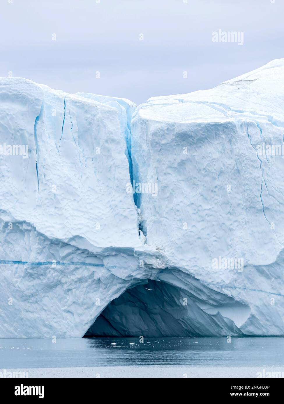A cave formed in a huge iceberg from the Ilulissat Icefjord stranded ...