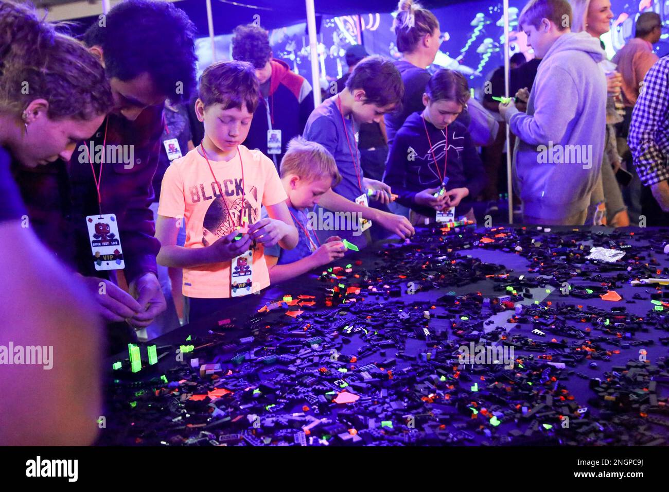 Kids and adults assemble glow in the dark LEGO creations during Brick ...