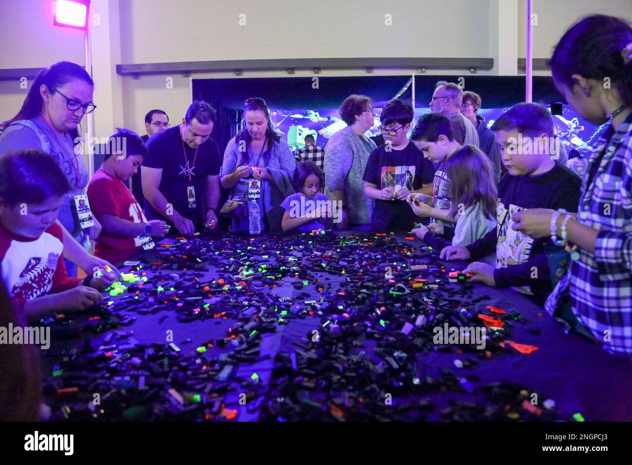 Kids and adults assemble glow in the dark LEGO creations during Brick ...
