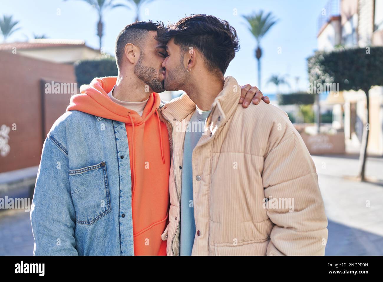 Two man couple hugging each other and kissing at street Stock Photo - Alamy