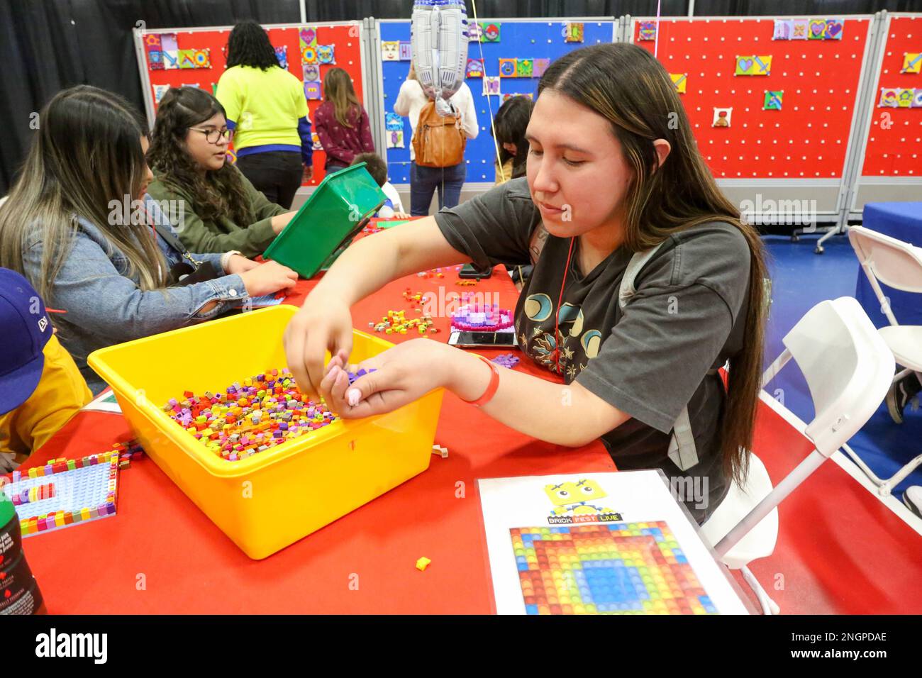 Families work together building LEGO boards with mini LEGO blocks ...