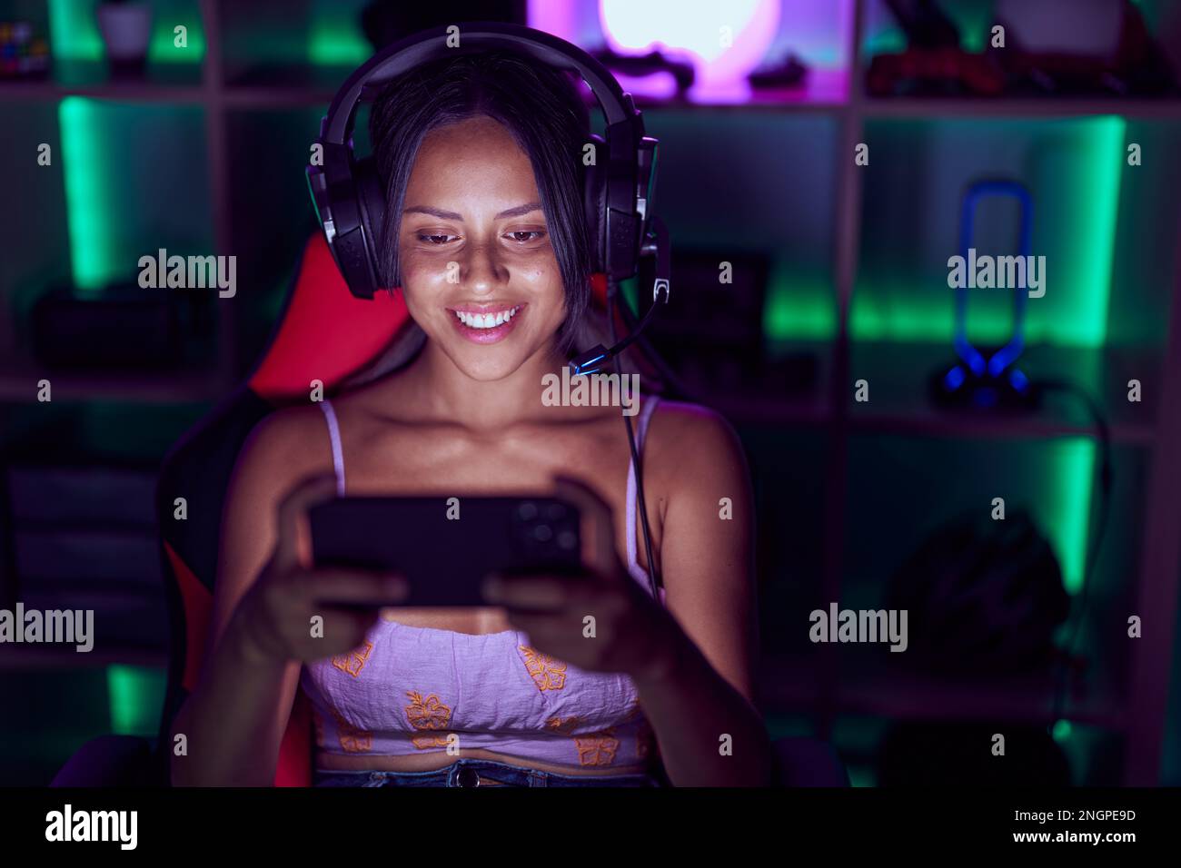Young hispanic woman streamer smiling confident playing video game at ...