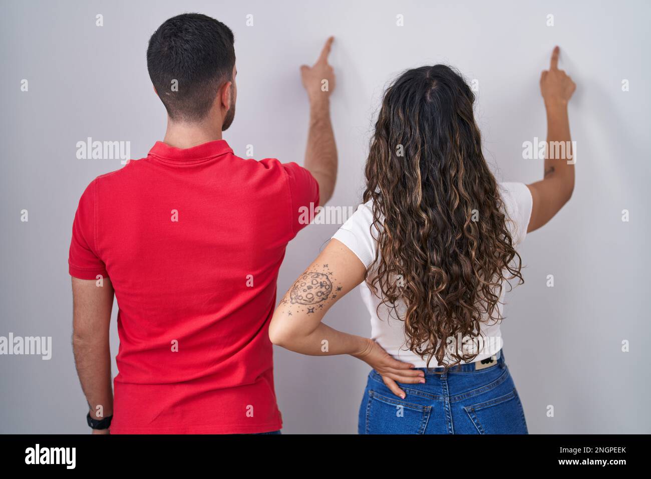 Young hispanic couple standing over isolated background posing ...