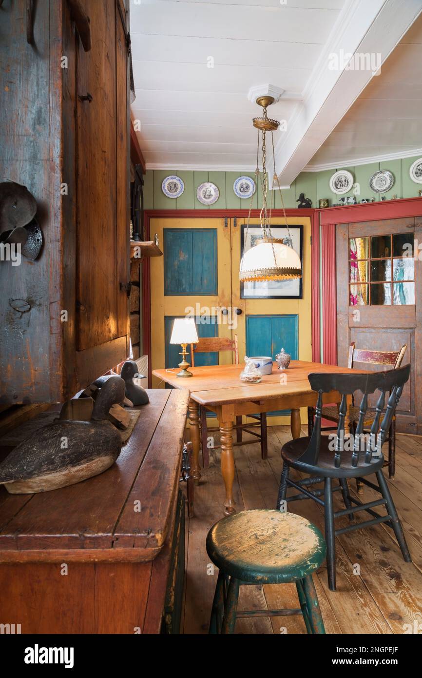 Antique wooden cabinets and pinewood dining table with assorted chairs ...