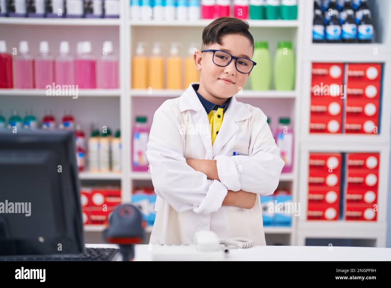 Young hispanic kid working at pharmacy drugstore happy face smiling ...