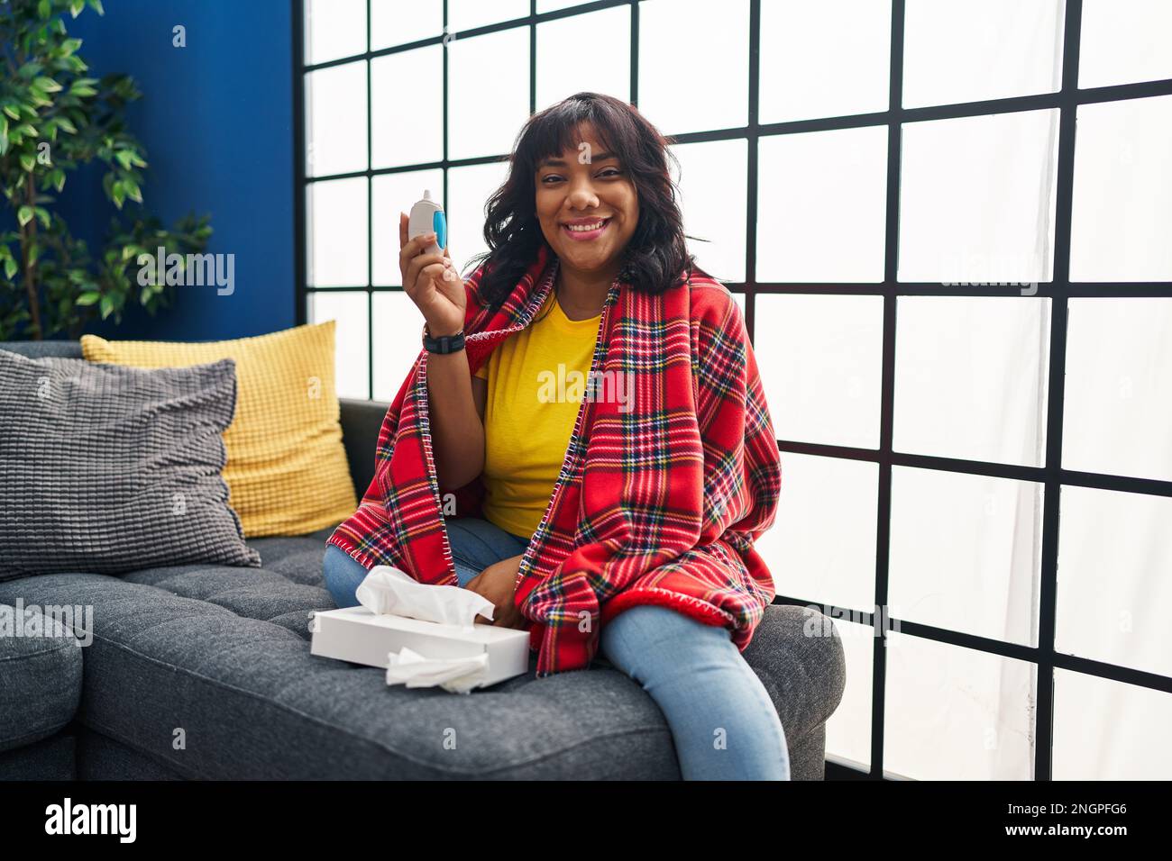 Hispanic woman holding medical asthma inhaler looking positive and ...