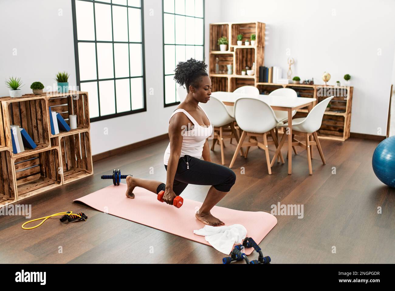 African american woman using dumbbells training at home Stock Photo - Alamy
