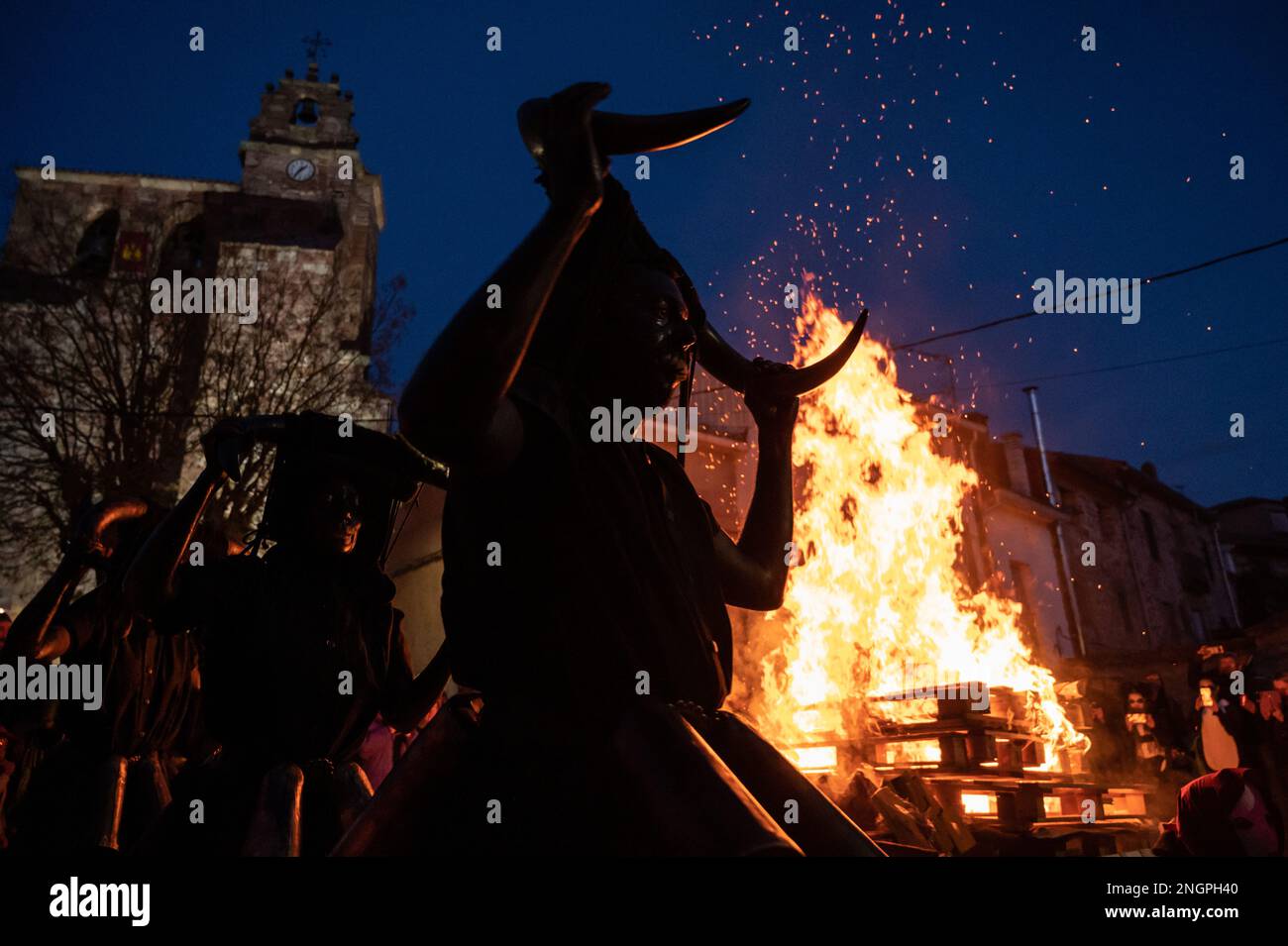 Luzon, Spain. 18th Feb, 2023. People dance by a bonfire with their ...