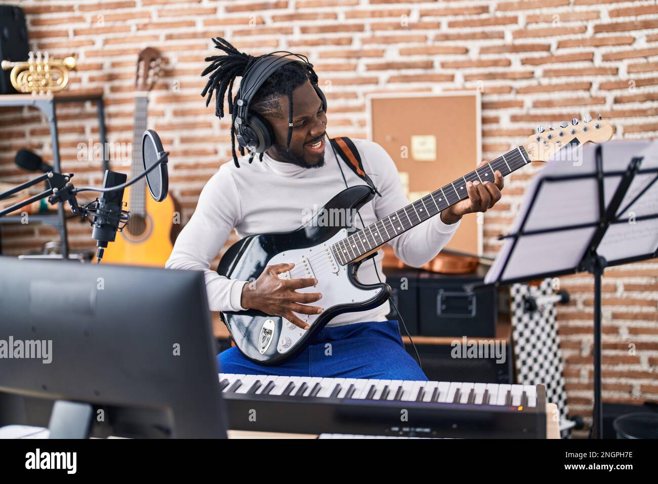 African american woman artist singing song playing electrical guitar at ...