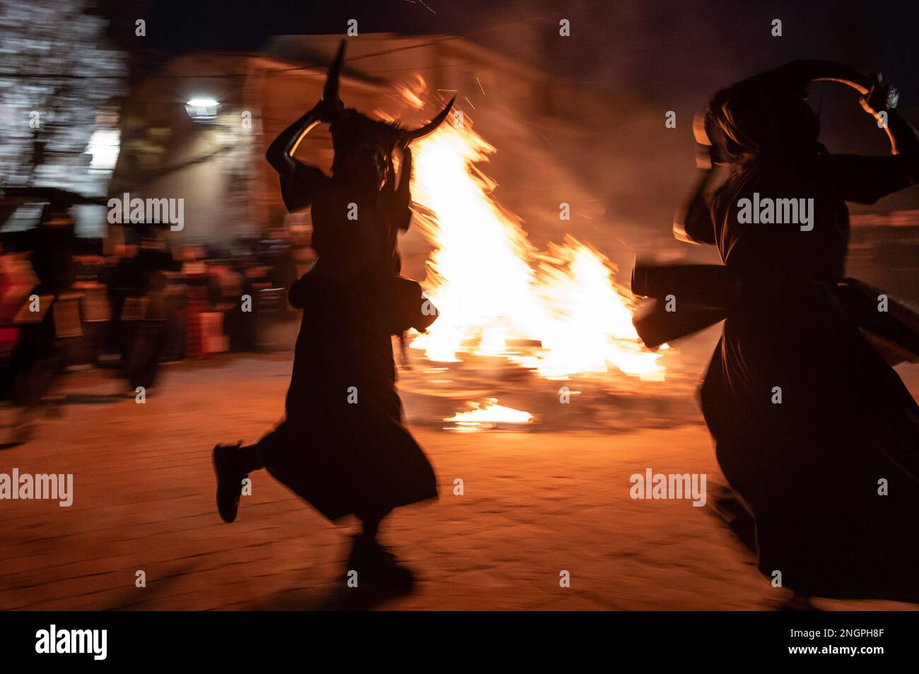 Luzon, Spain. 18th Feb, 2023. People dance by a bonfire with their ...