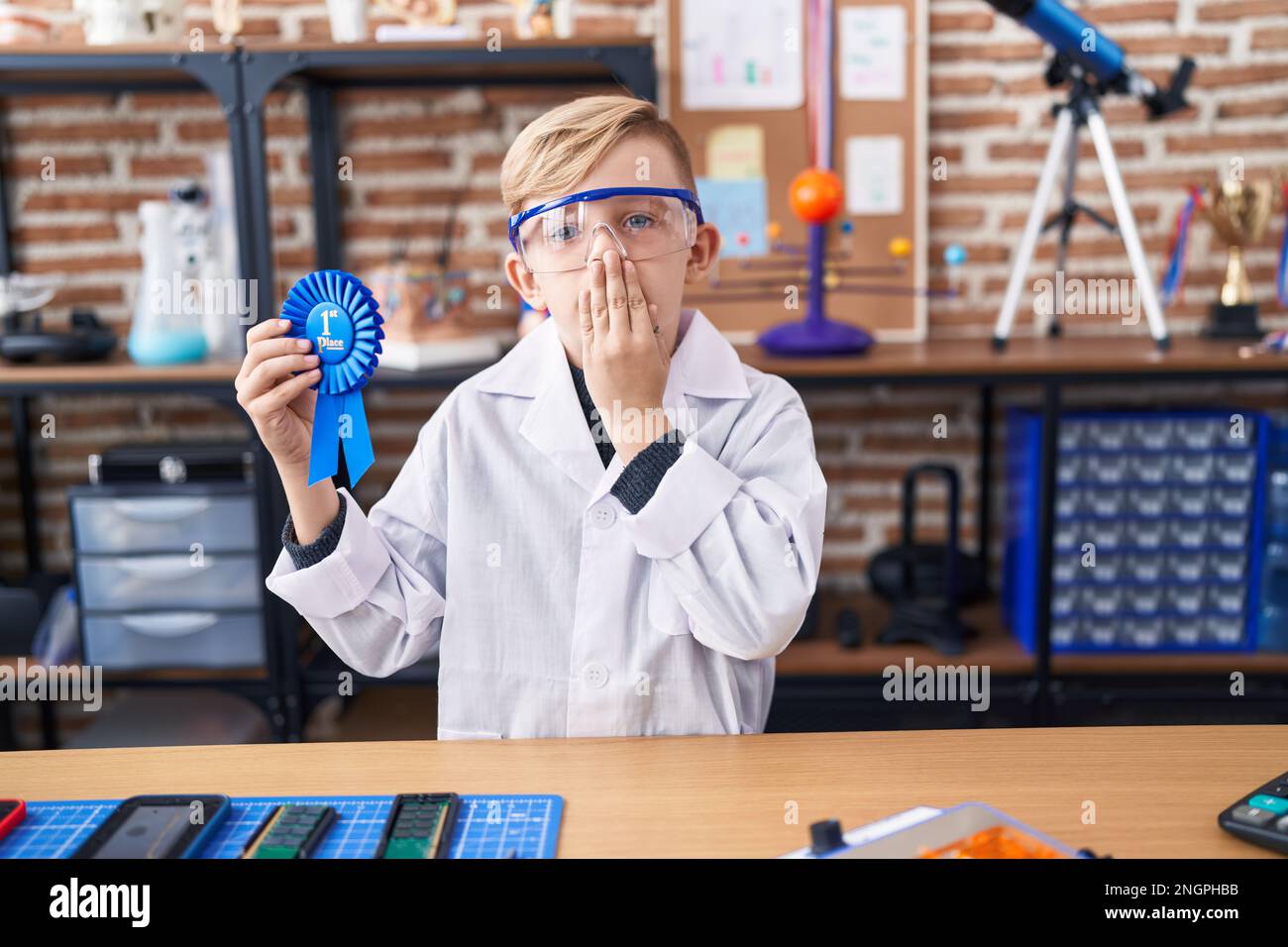 Little caucasian boy at school scientist laboratory winning first prize ...