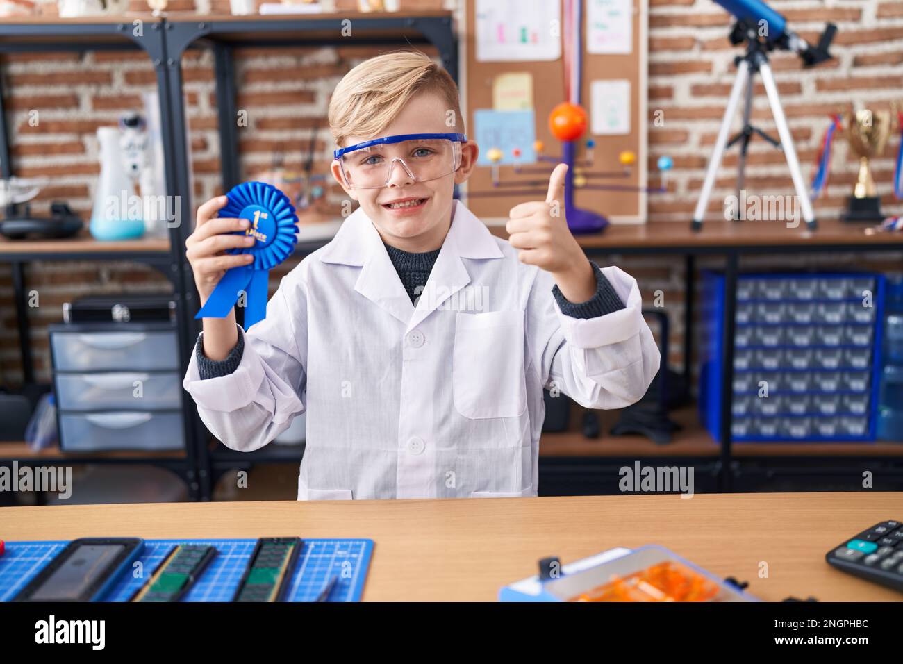 Little caucasian boy at school scientist laboratory winning first prize ...
