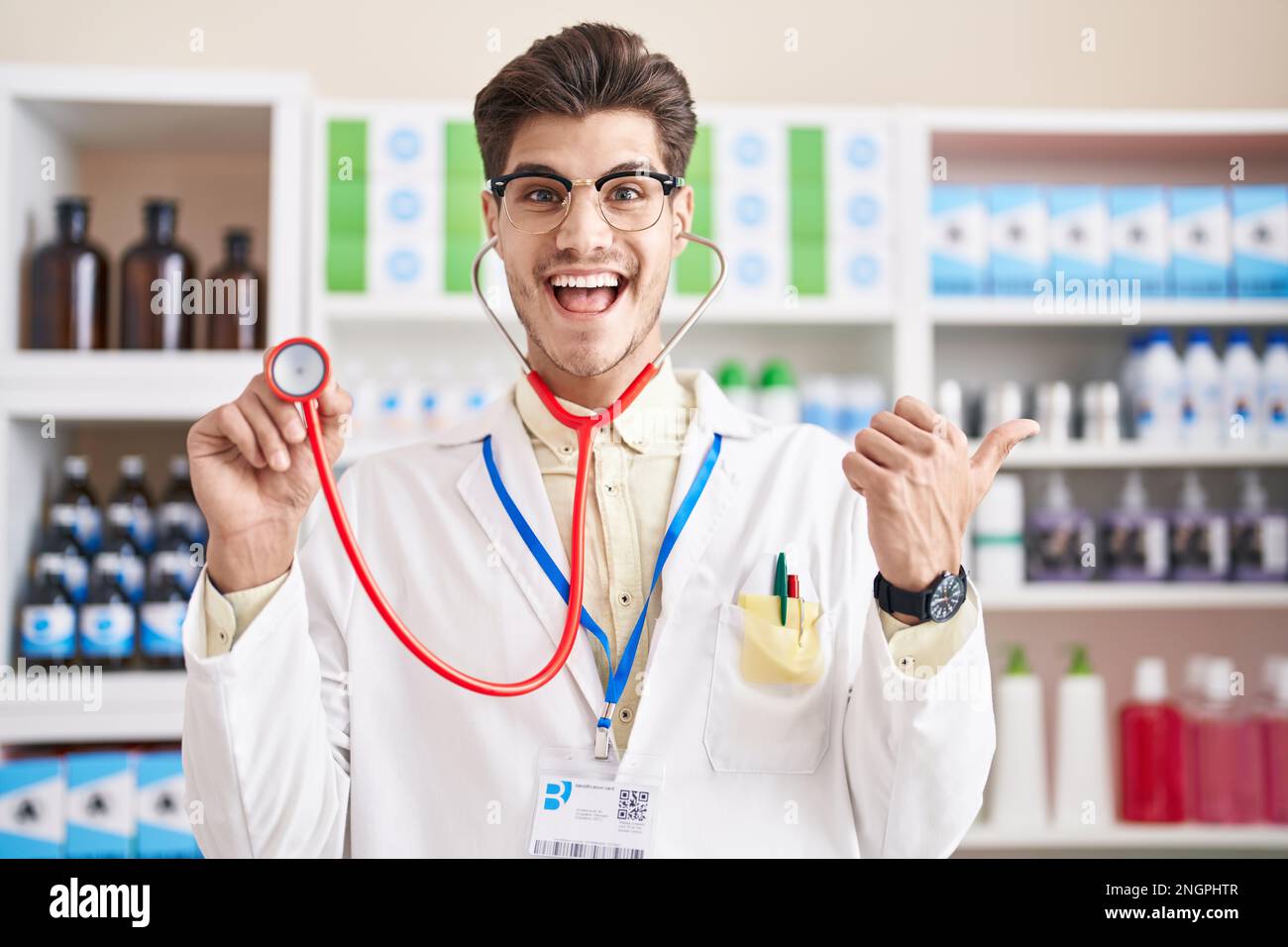 Young hispanic man working at pharmacy drugstore using stethoscope ...