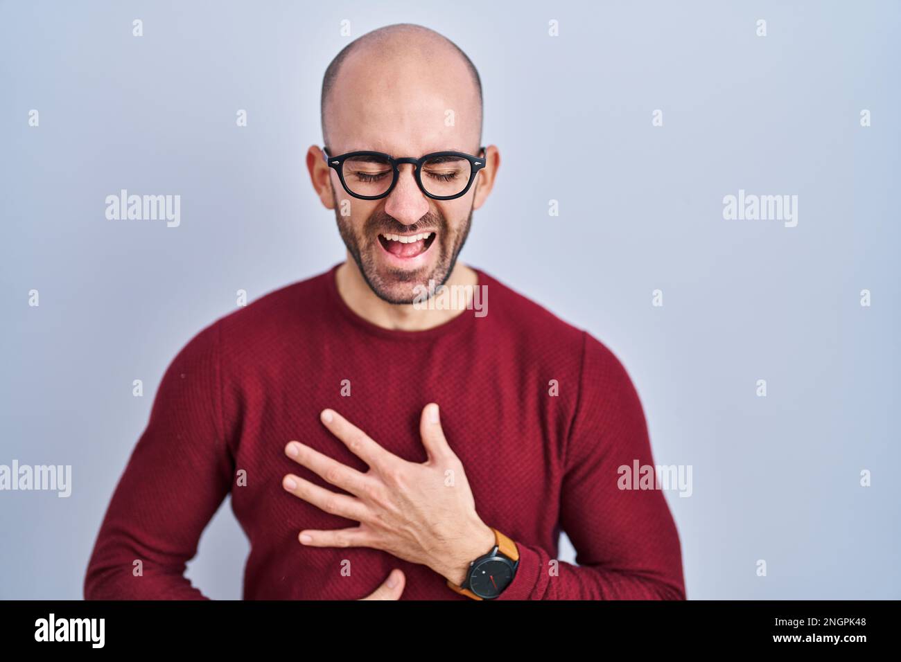 Young Bald Man With Beard Standing Over White Background Wearing Glasses Smiling And Laughing